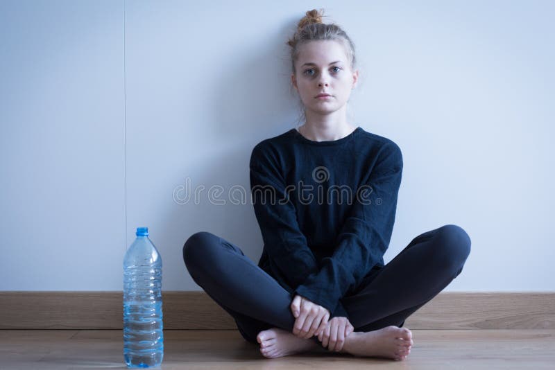 Anorexic Girl Lying on Floor, Suffering from Stomach Pain, Nausea ...