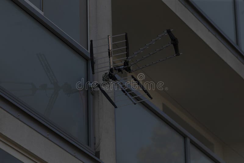 An Antenna is Securely Mounted on the Side of a Tall Building Stock ...