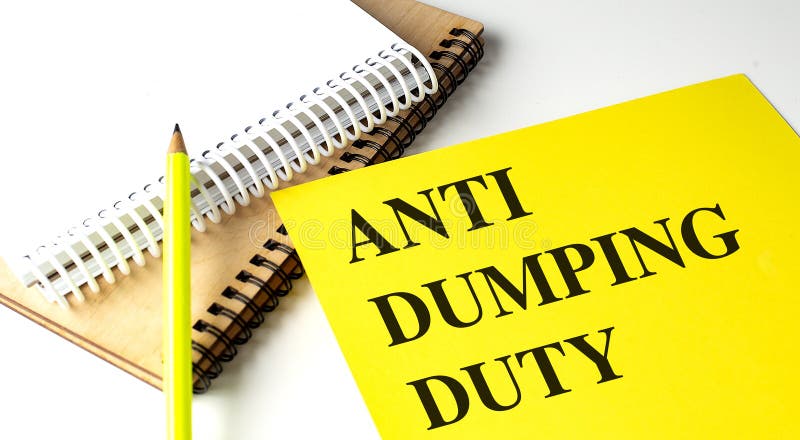 ANTI DUMPING DUTY Text on Yellow Paper with Notebooks Stock Photo ...