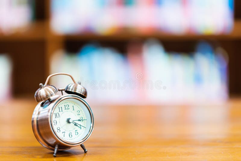 Antique Alarm Clock on the Wood in the Library Stock Image - Image of ...