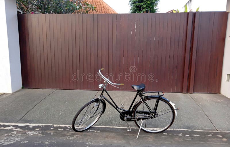 An Antique Bicycle Park in Front of Gate with Wooden Style Stock Photo ...