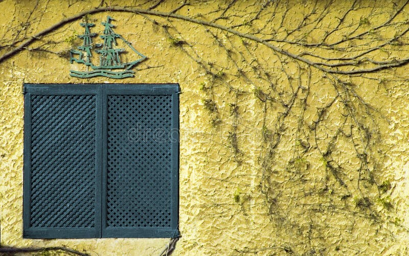 Antique Blue Window Against Yellow Wall Picture. Image: 5212999