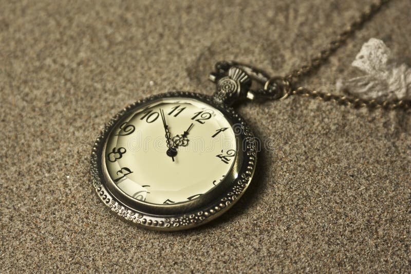 Antique clock in the sand stock photo. Image of number - 51201470