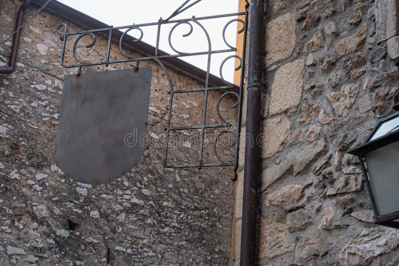 Antique Empty Wrought Iron Sign Hanging on a Wall Stock Photo - Image ...