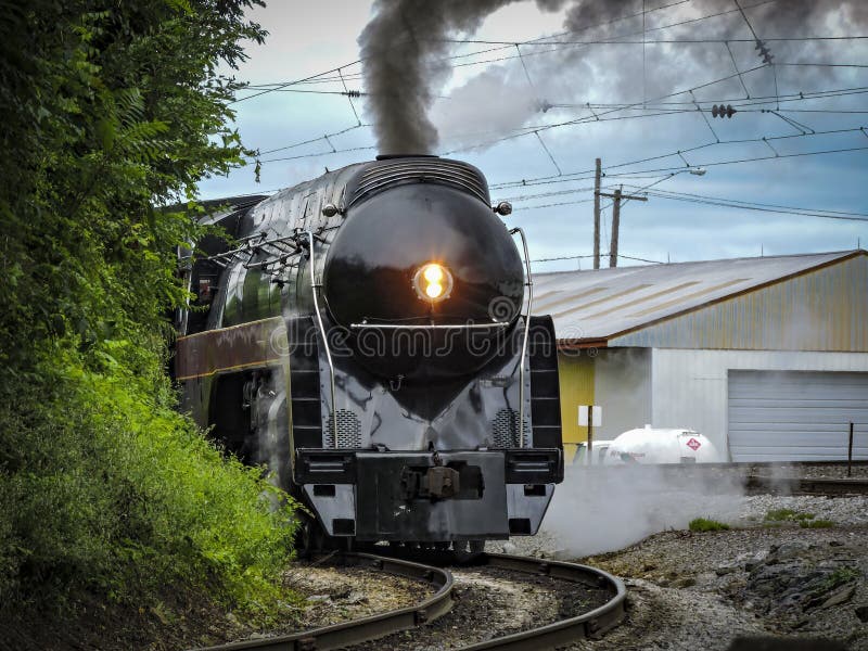 An Antique Restored Steam Engine Approaching Around a Curve Blowing ...