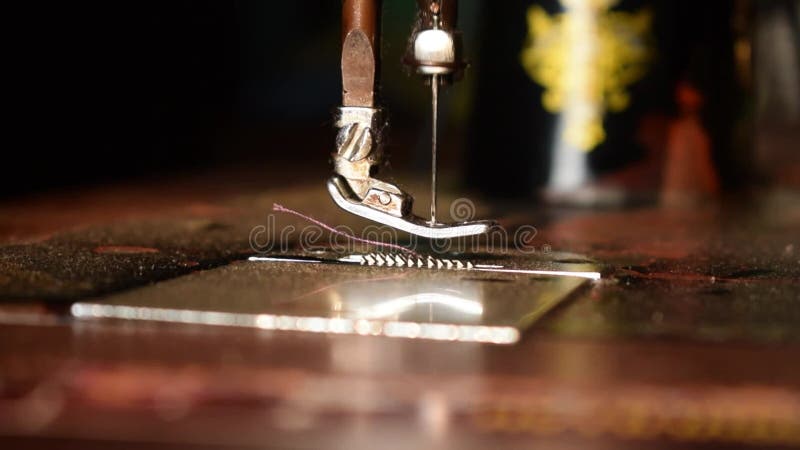 An Antique Sewing Machine and Needle Working on Table Wood Stock ...