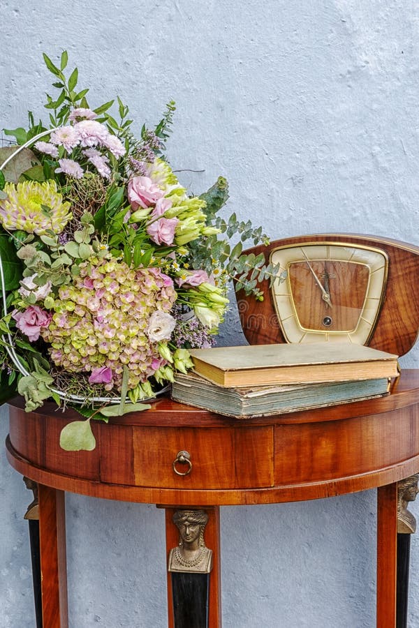 Antique Sideboard with Flowers, Old Clock and Old Books Stock Photo ...