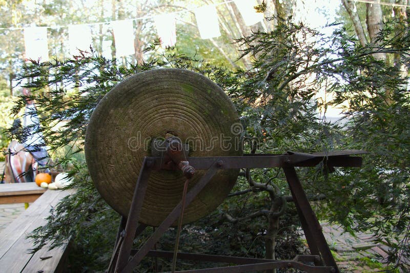 Antique Stone Grinding Wheel in a Garden Stock Image - Image of ...