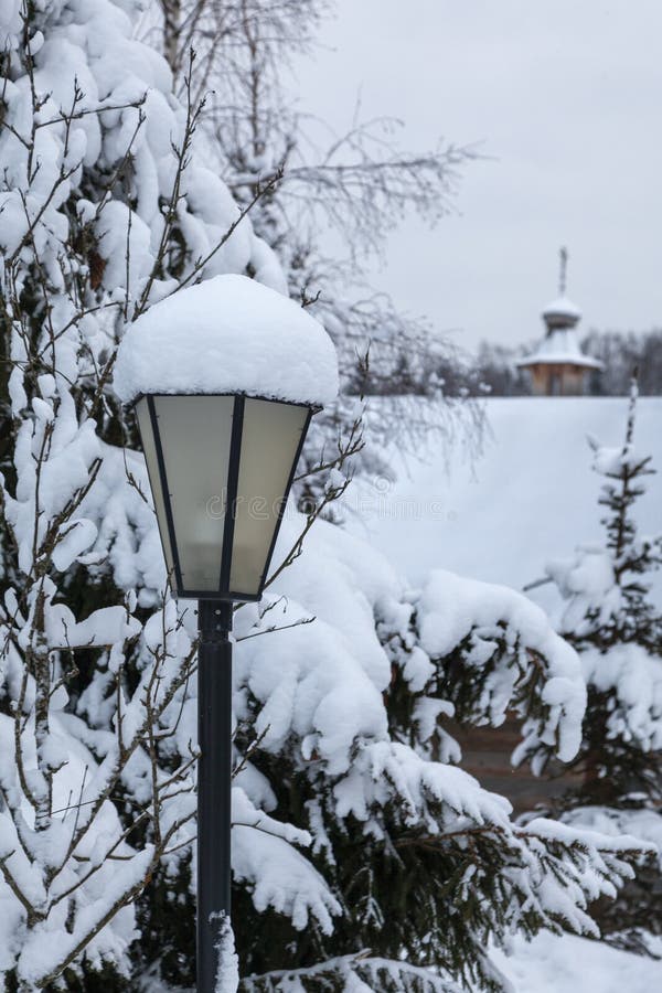 An Antique Street Lamp Covered with Snow Against the Background of a ...