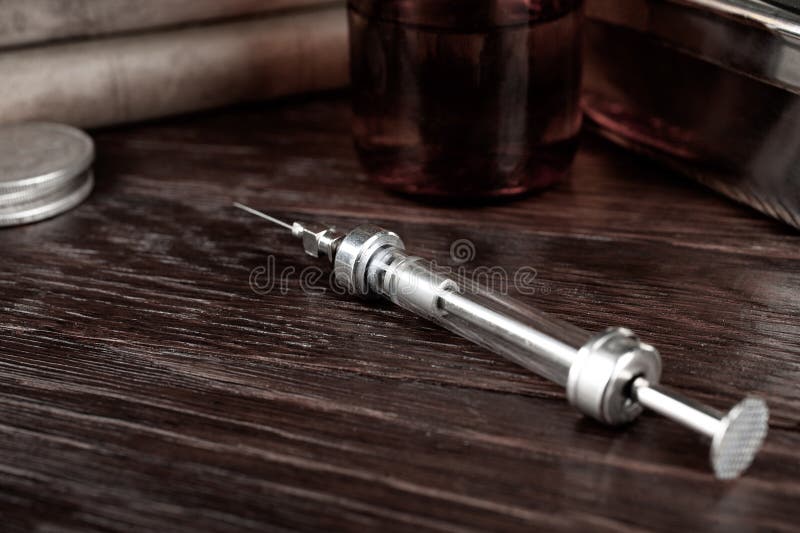 Antique syringe on a table stock image. Image of injection - 287092483