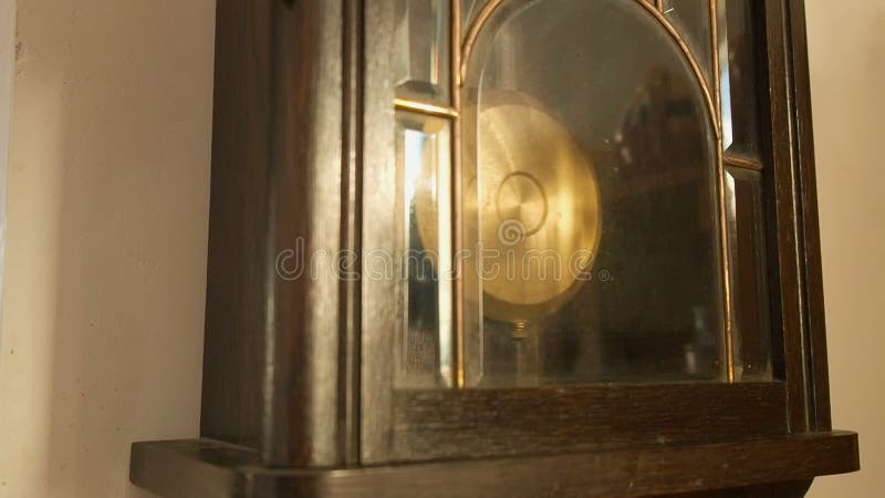 Antique Wall Clock with a Pendulum. Man`s Hand Stopping Pendulum ...