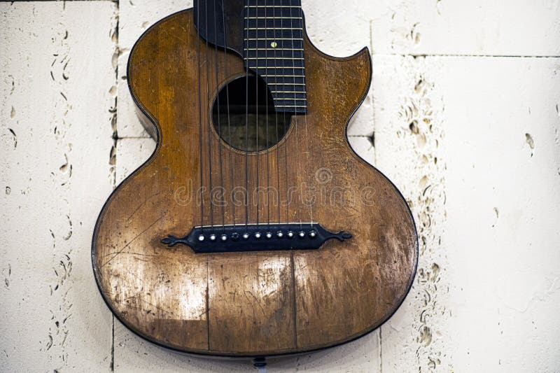 Antique Working Guitar on a Light Wall. Stock Image - Image of luthier ...