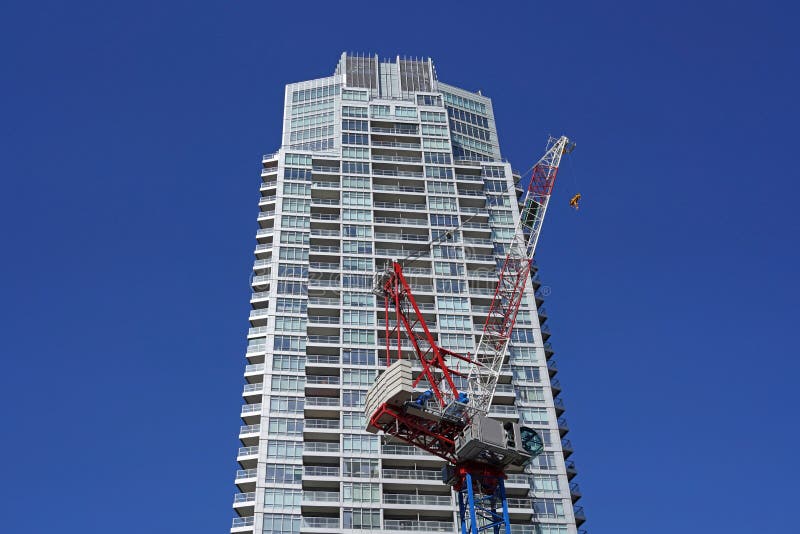 Apartment Building beside Crane To Construct a New Building Stock Photo ...