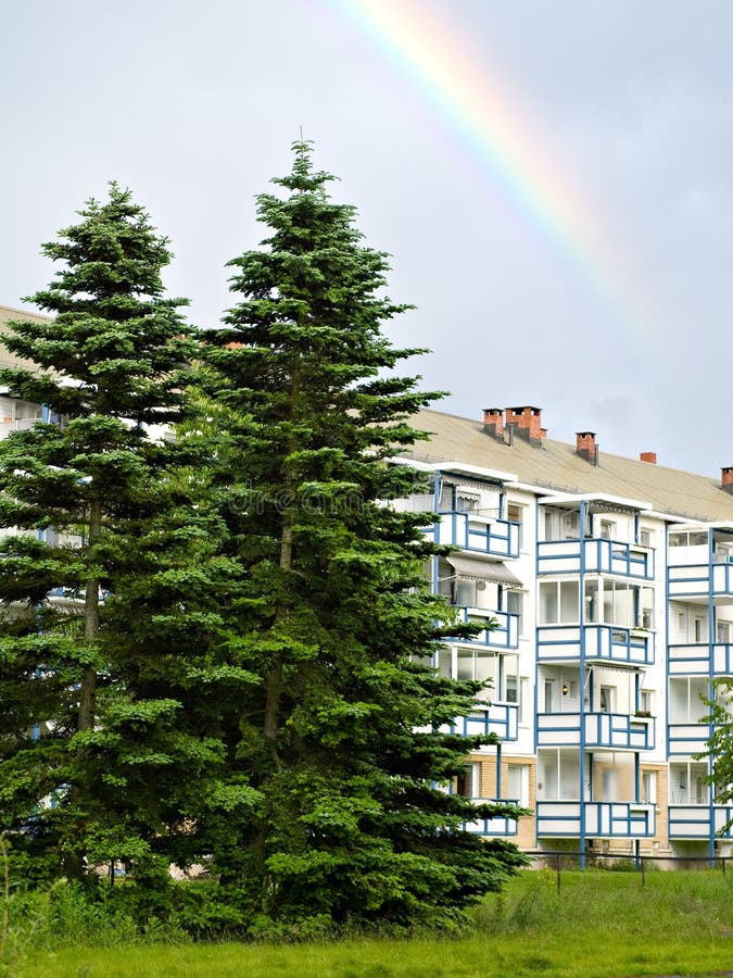 Apartment Building, Spruce Trees and Rainbow Stock Image - Image of ...