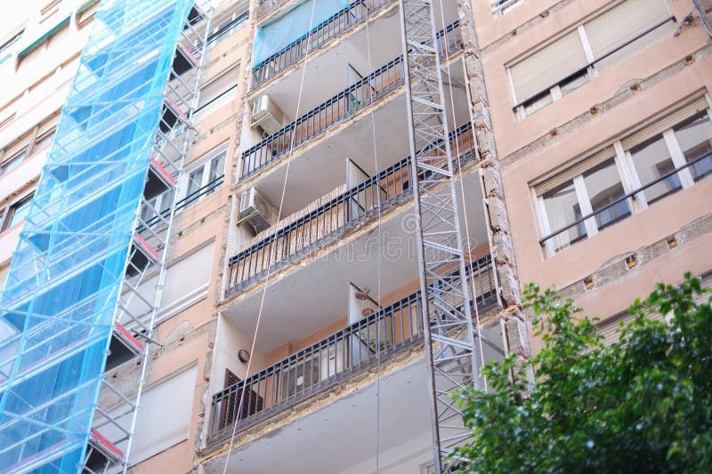 Apartment Building Under Renovation with Scaffolding and Netting on ...