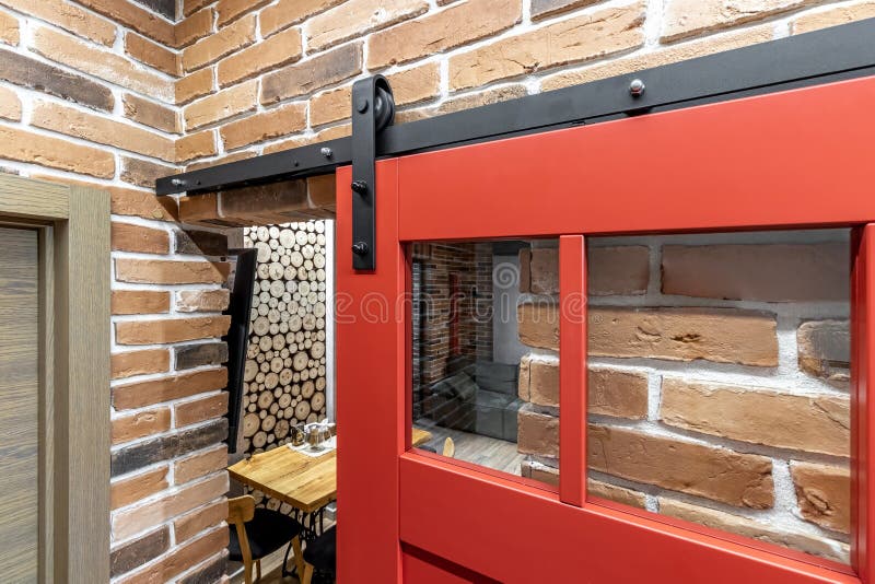 Apartment Interior with Sliding Red Door and Clay Red Brick Wall ...