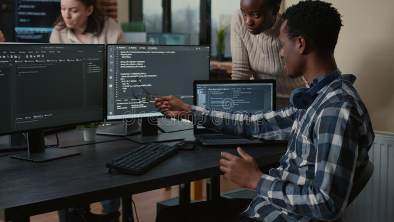 App Developer Removing Glasses while Explaining Algorithm To Colleague Programer Stock Footage ...