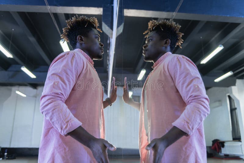 Appealing Concentrated Young Man Looking on Himself in Mirror Stock ...