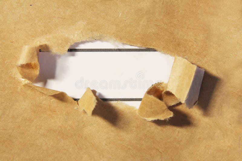 Hole in the brown paper stock photo. Image of break - 276963186