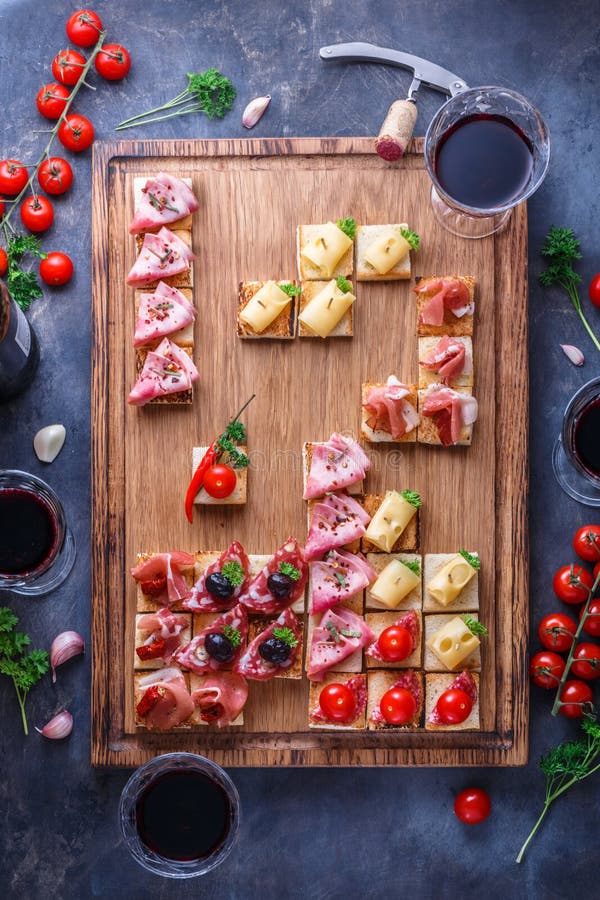 Appetizers Cutting Board with Assorted Snacks and Wine Stock Photo ...
