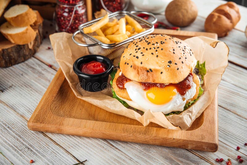 Appetizing Burger on a Wooden Tray with Knife, with French Fries Stock ...