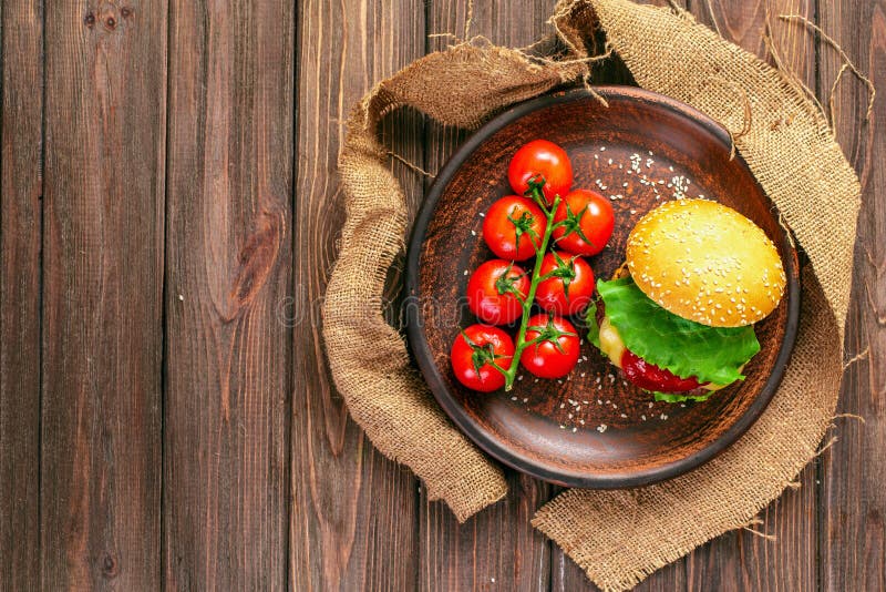 Appetizing Burger with Tomatoes on Table Stock Photo - Image of meal ...