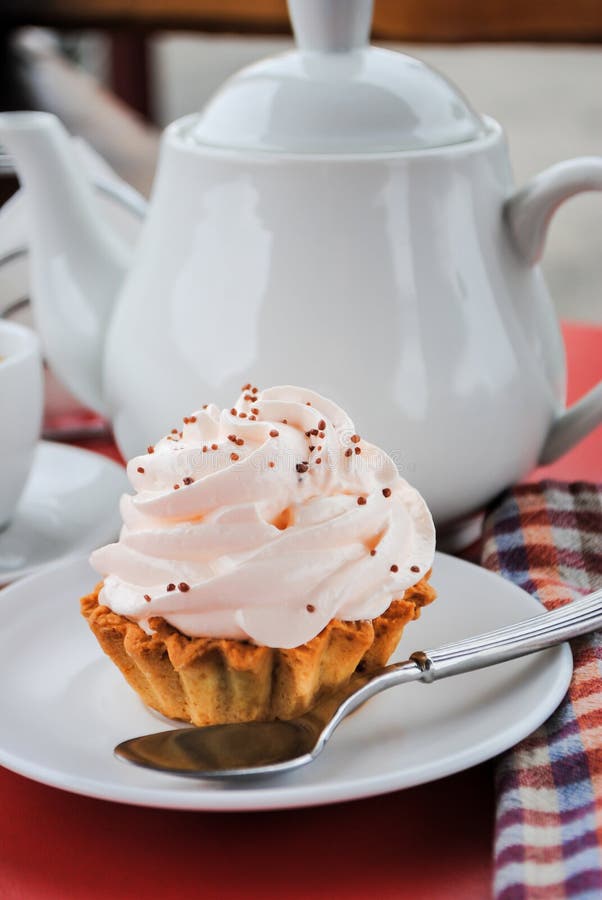 Appetizing Cake with Pink Cream and Sprinkling on a Table with a Stock ...