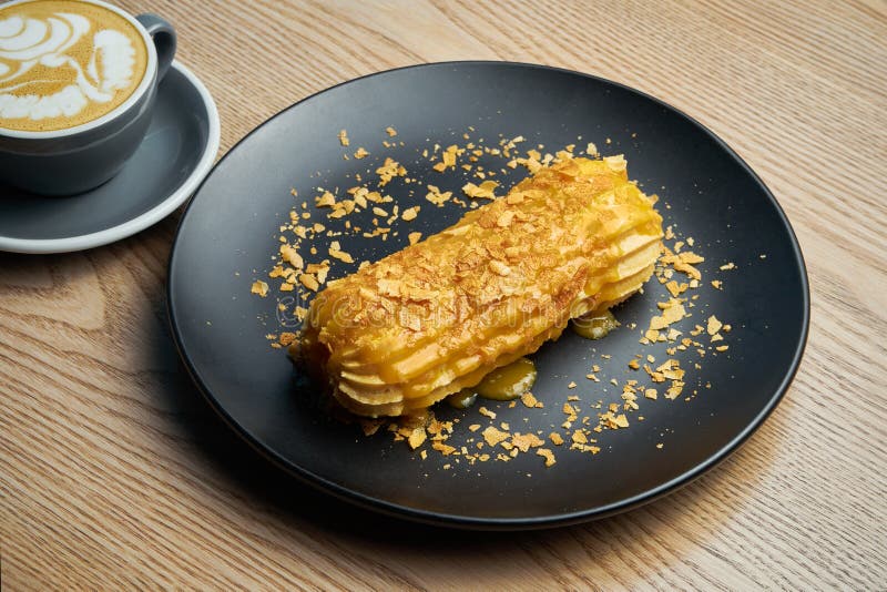 Appetizing and Large Eclair with Glaze of Mango on Top and Fir Cream ...