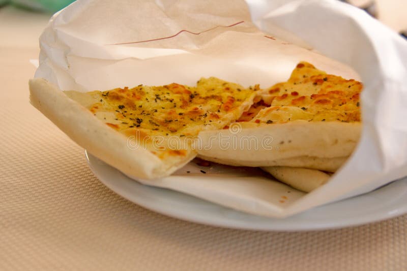Appetizing Not Fried Pizza in White Paper on a White Plate Lies on a ...