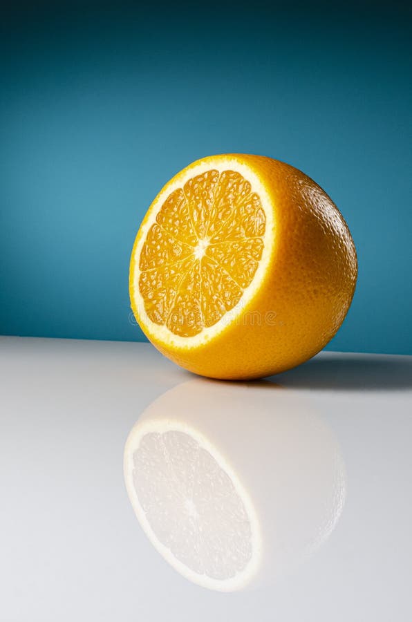 Appetizing Orange, with Reflection on a Blue Background Stock Image ...