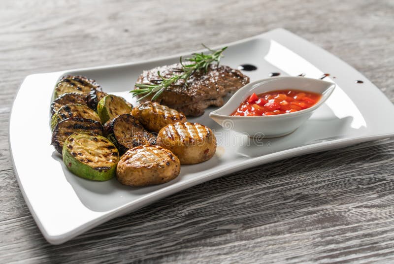 Appetizing Stake on White Plate. Grilled Meat Stock Photo - Image of ...