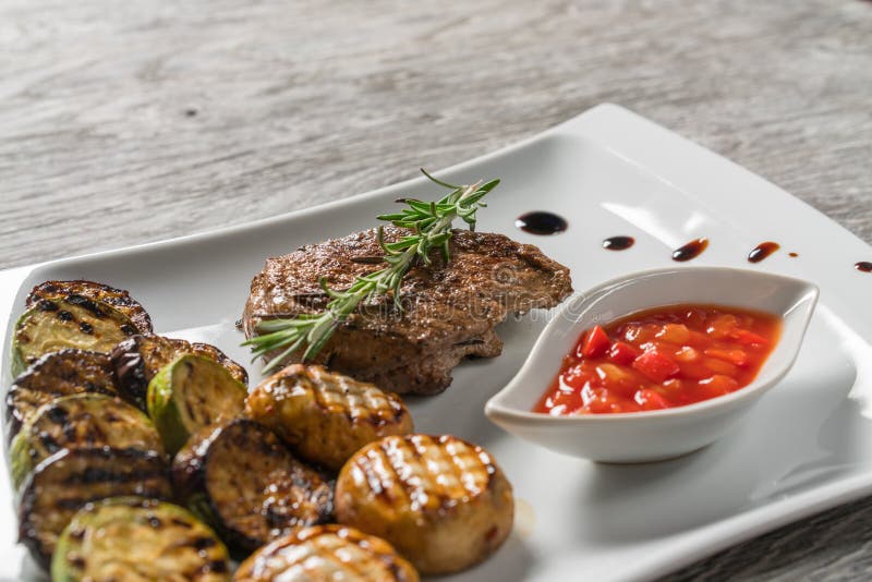 Appetizing Stake on White Plate. Grilled Meat Stock Photo - Image of ...