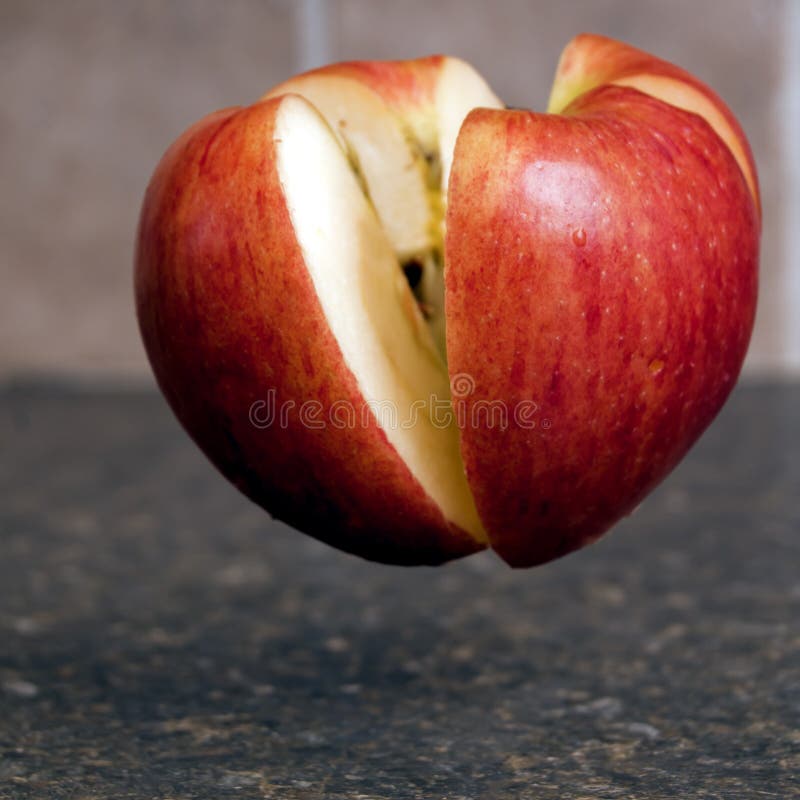 Apple Being Cut in Half stock photo. Image of apple, kitchen - 18936022