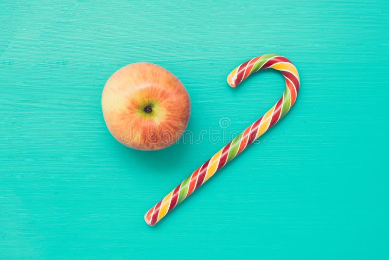 Apple and candy cane stock image. Image of candy, fruit - 57770831