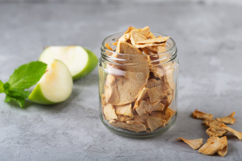 Apple Chips in a Jar and Pieces of this Fruits on a Table Stock Image ...