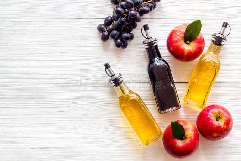 Apple Cider and Balsamic Vinegar in Bottles with Grapes and Red Apples ...