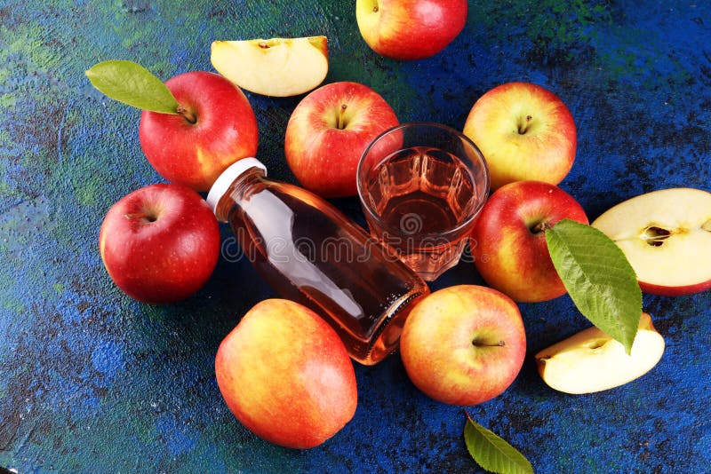 Apple Cider Drink and Organic Apples with Leaves on Table Stock Photo ...