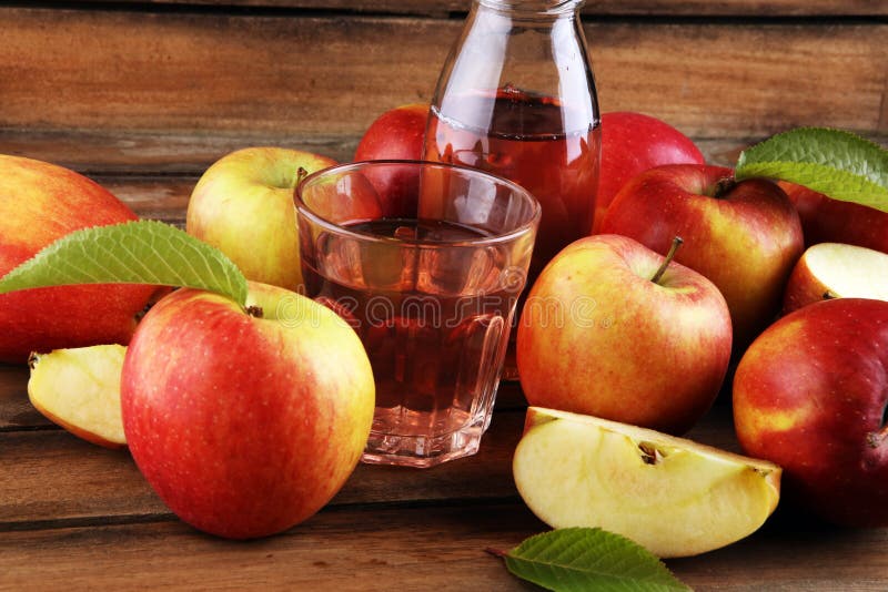 Apple Cider Drink and Organic Apples with Leaves on Table Stock Image ...