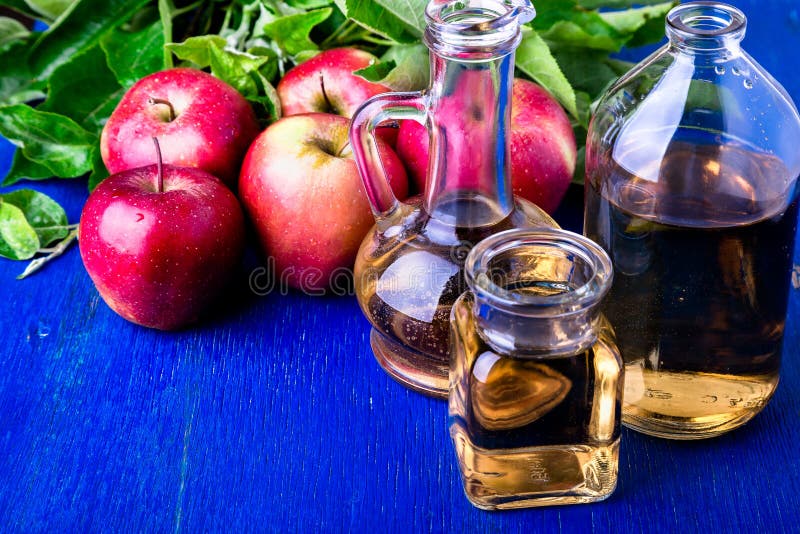 Apple Cider Vinegar. Three Glass Bottle on Blue Background. Red Apples ...