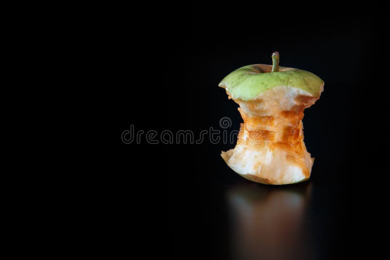 An Apple Core on a Black Background with Reflexion. Ecology Concept ...