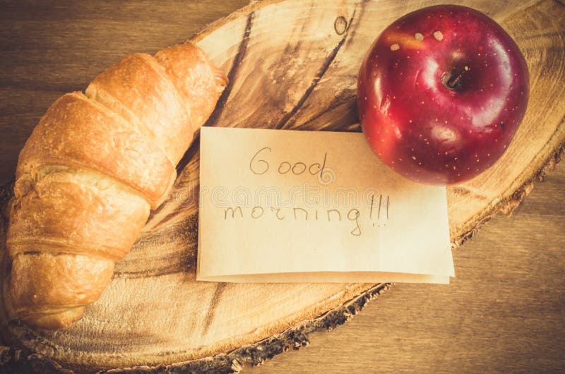 Apple, Croissant and Good Morning Note on Rustic Wooden Background ...