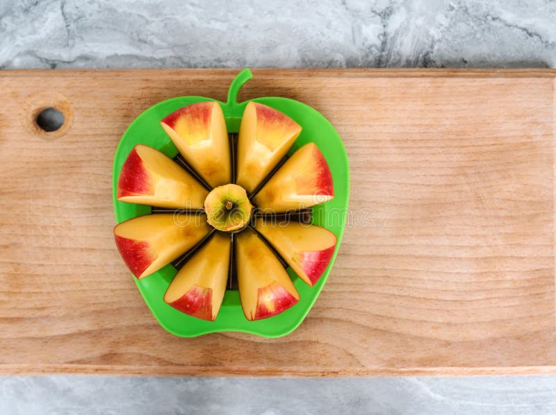 An Apple is Cut into Slices Using a Special Slicer in the Shape of an ...