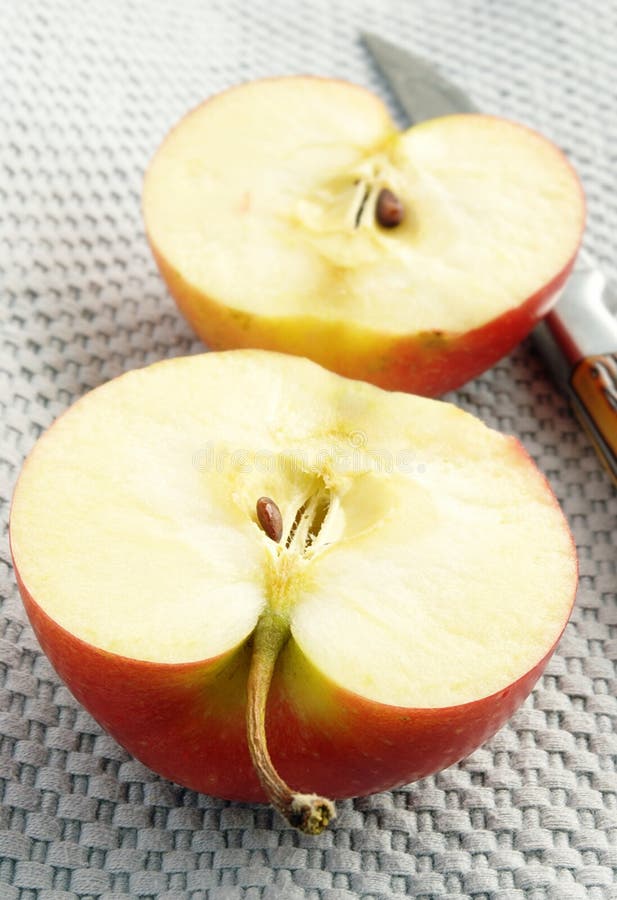 Apple cut into two pieces stock image. Image of fruit - 23628549
