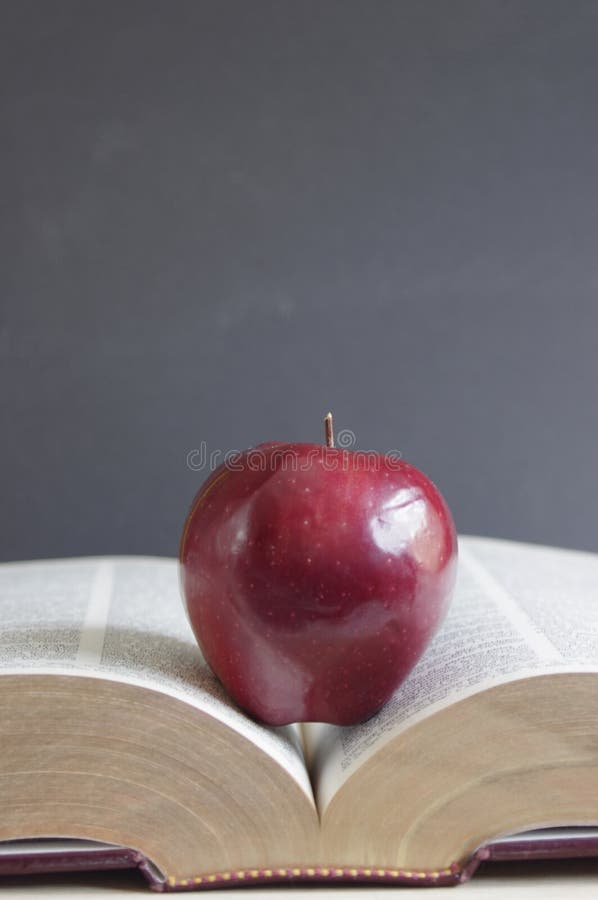 Apple on dictionary stock photo. Image of gold, open - 72657456