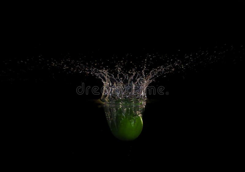 Apple Falling Down into Clear Water Against Black Background Stock ...