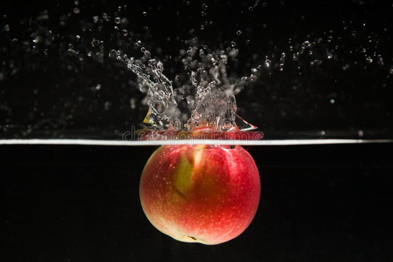 Cut Apple Falling into Juice on White Background Stock Image - Image of ...