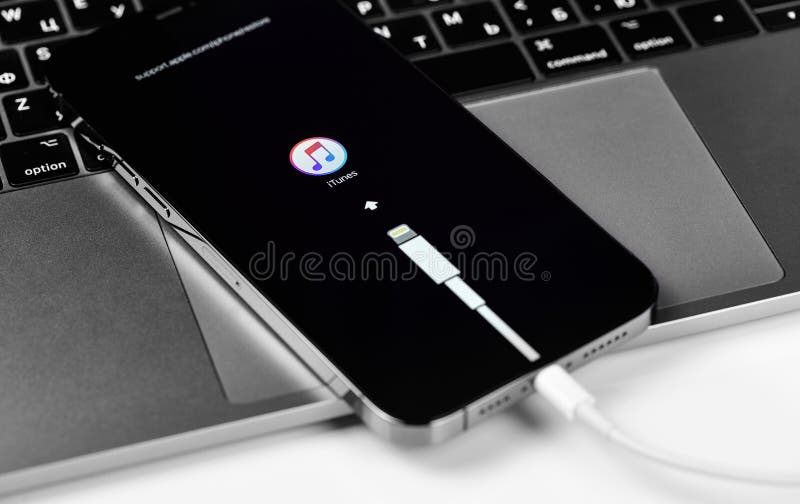 Apple IPhone with Lightning Cable, ITunes Logo on the Screen Editorial ...