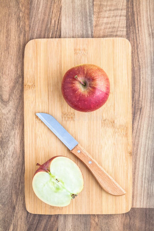 Knife Cutting An Apple On Chopping Board Stock Image - Image of half ...