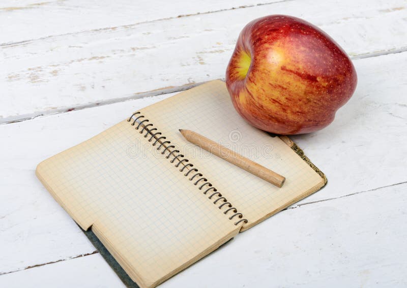 Apple and Notebook on a Table Stock Image - Image of retro, office ...