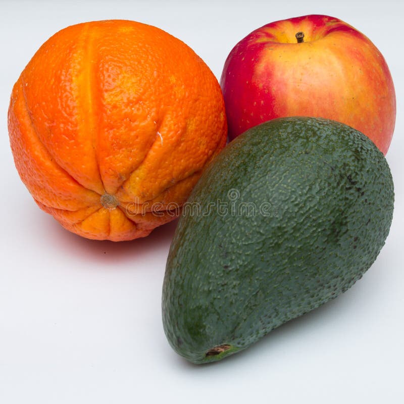 Apple, Orange and an Avocado on White Background Stock Photo - Image of ...